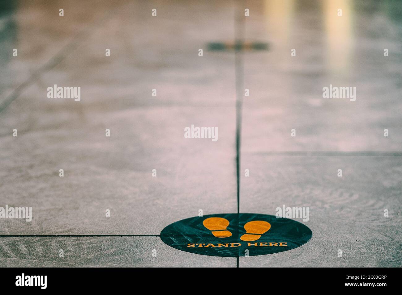 Stand here foot sign or symbol on the floor Stock Photo - Alamy