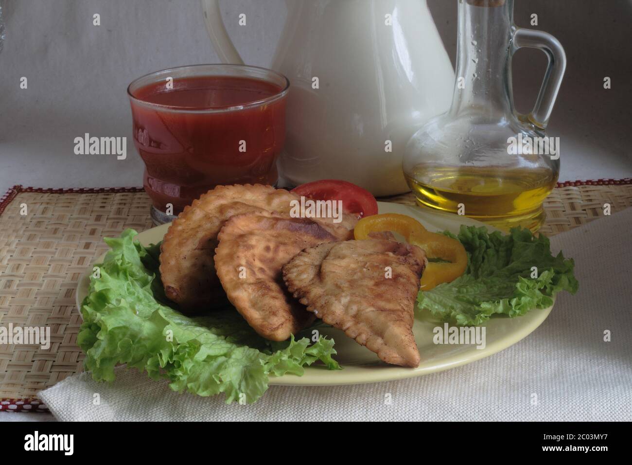 cheburek submitted with leaves of green salad and Stock Photo - Alamy