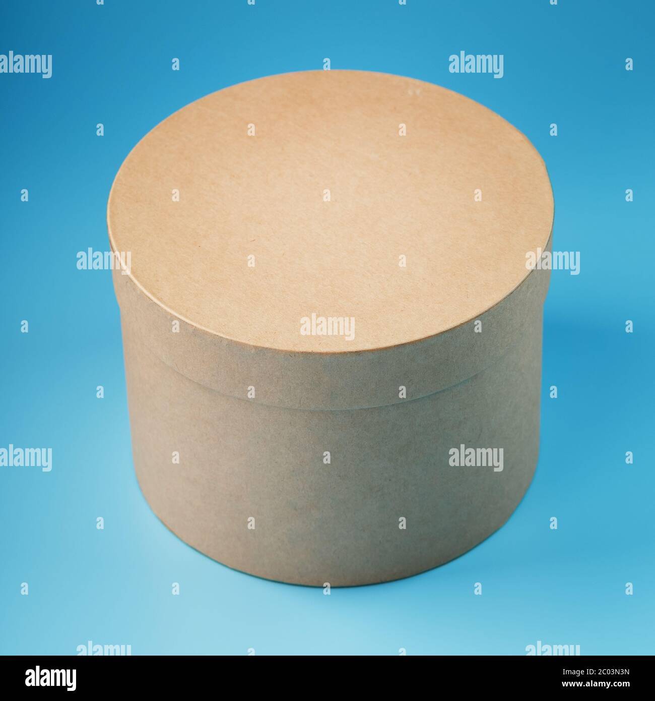 Round cardboard box on a blue background, free space Stock Photo - Alamy