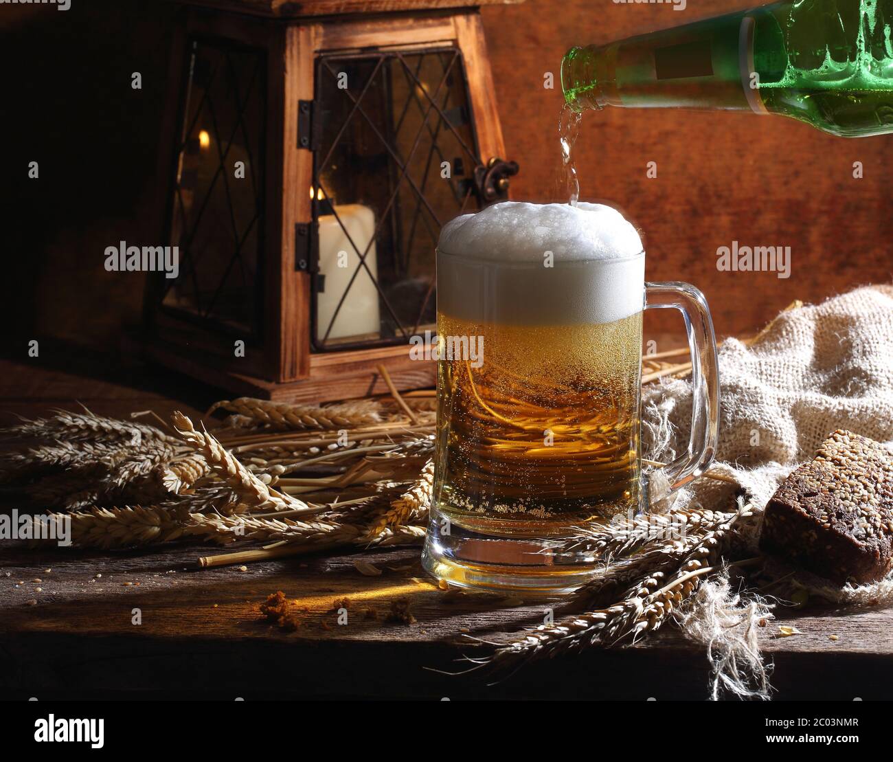 Beer from a bottle pour in a mug Stock Photo - Alamy