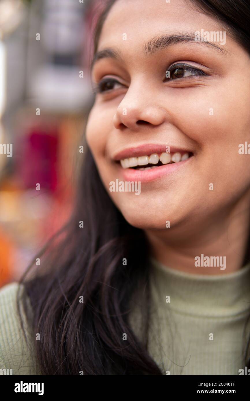 Close-up of happy late teen girl looking away with toothy smile Stock ...