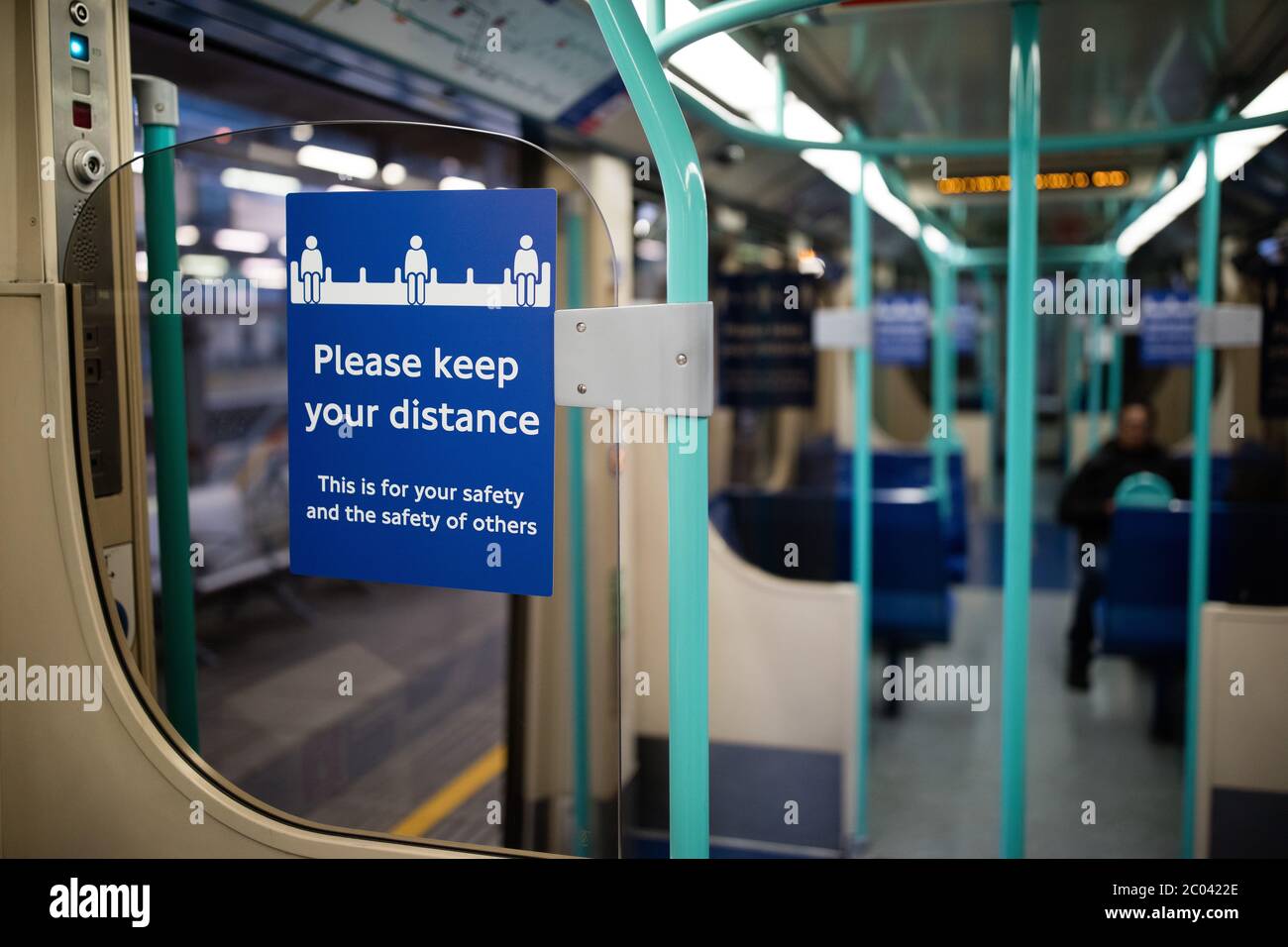 Please keep your distance sign on a DLR train, London Stock Photo - Alamy