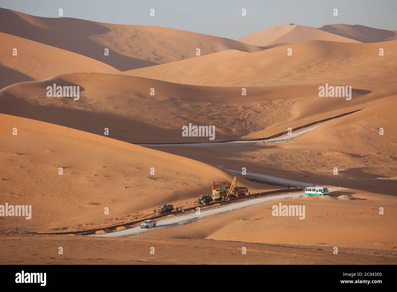 An oil company welding together an export pipeline in the Sahara desert ...