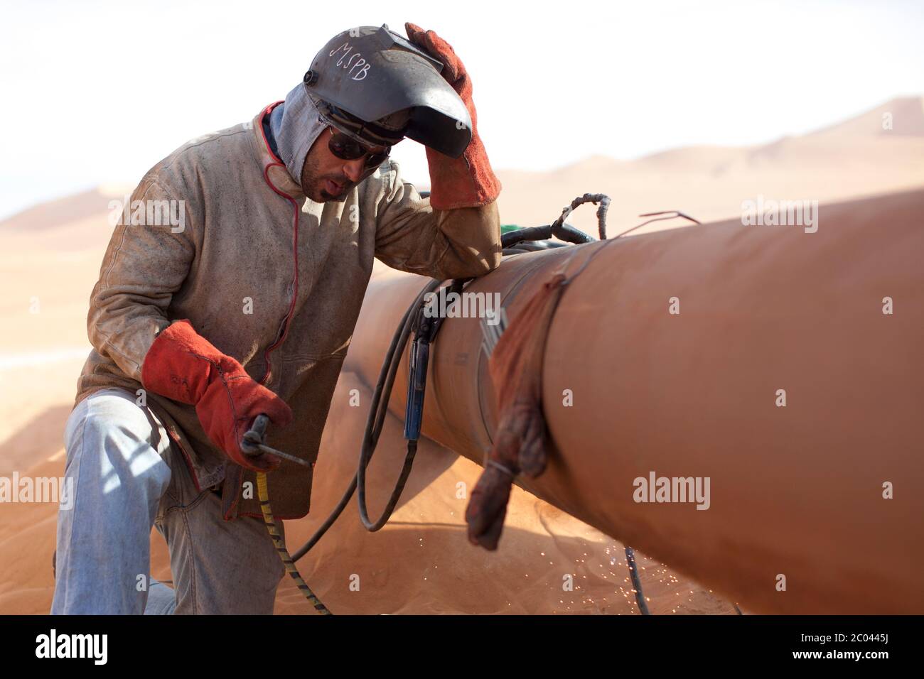 A welder takes a moment's rest while Welders join together an export ...
