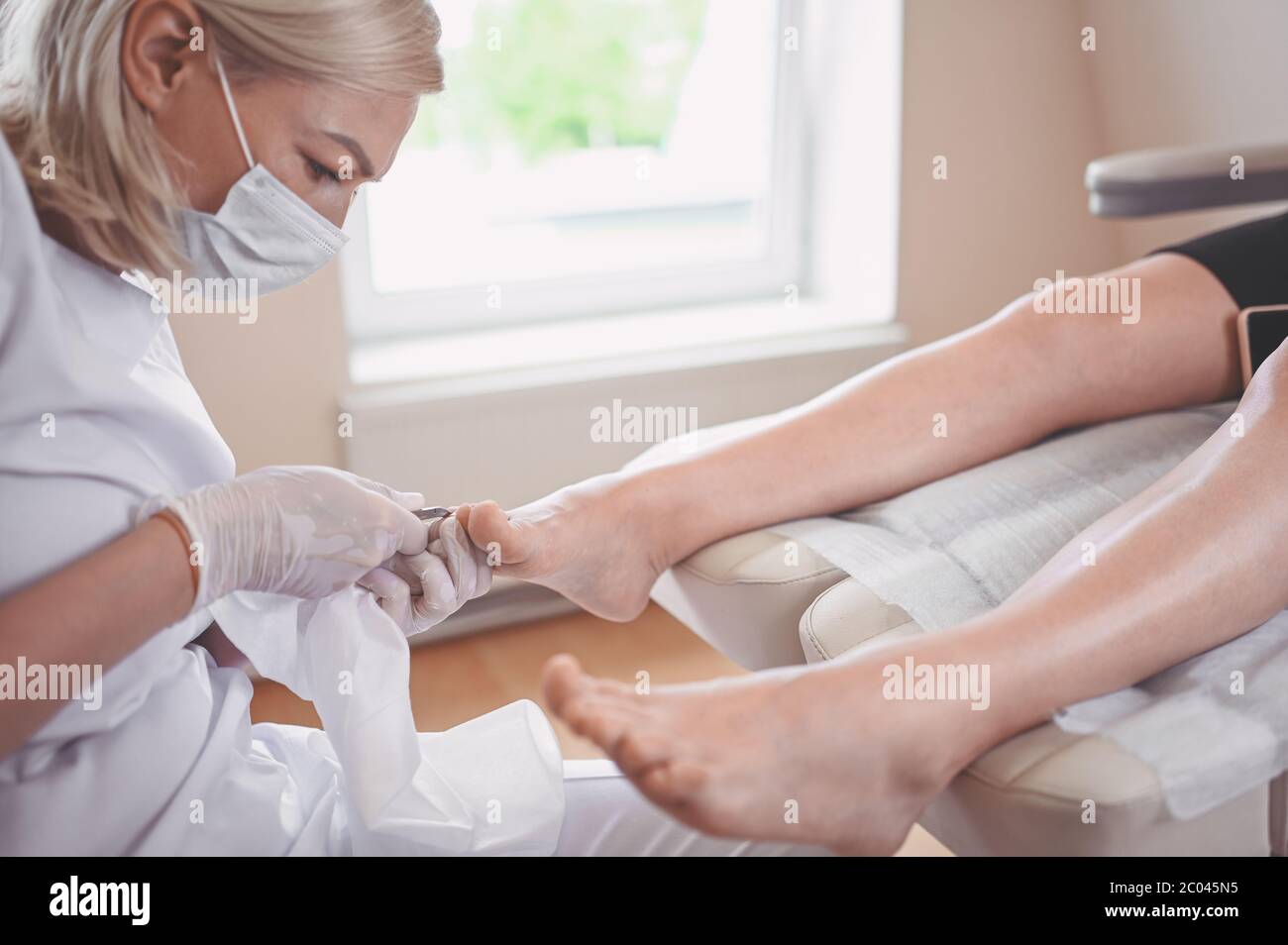 Professional medical pedicure procedure close up using nail clippers ...