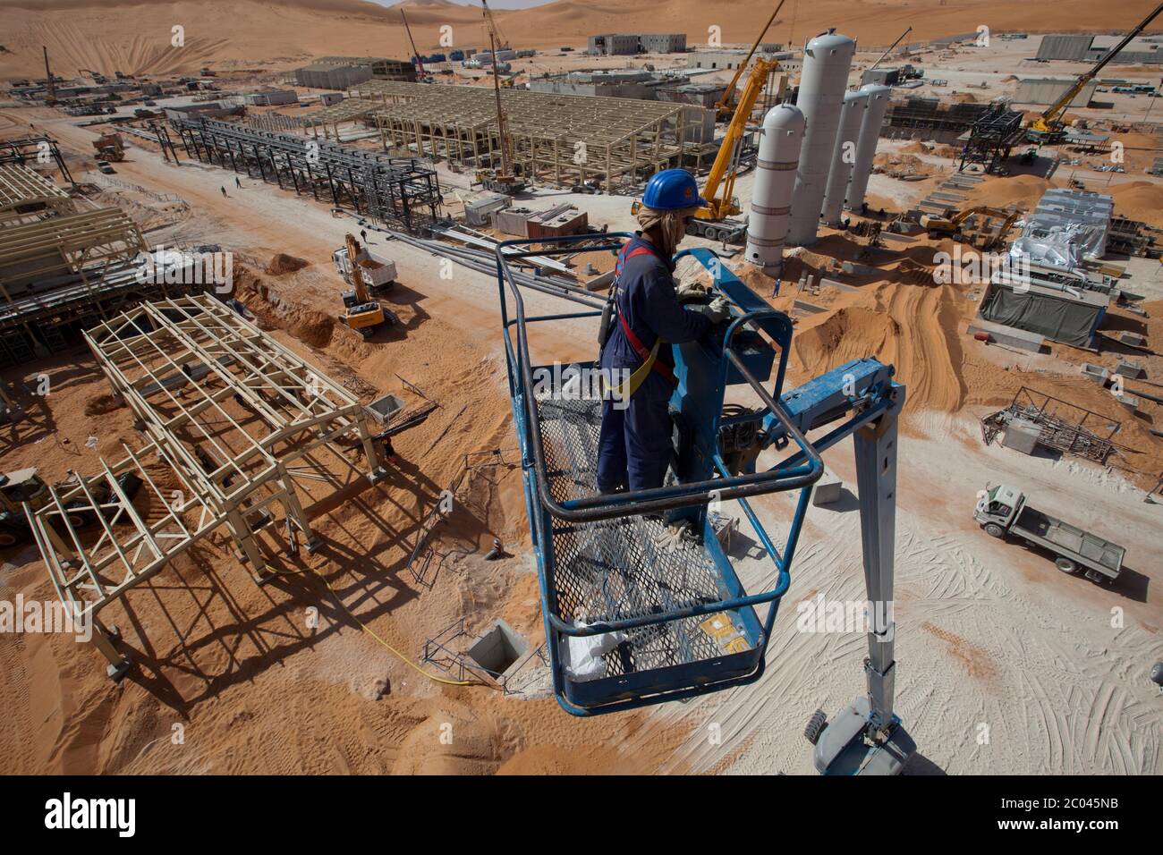 An engineer uses a high lift platform as major pieces of oil and gas ...