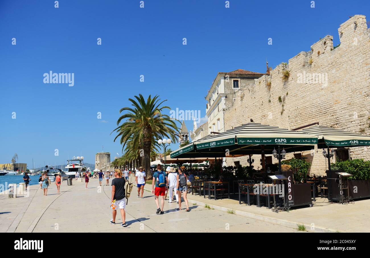 The waterfront promenade outside the old town city walls of Trogir ...