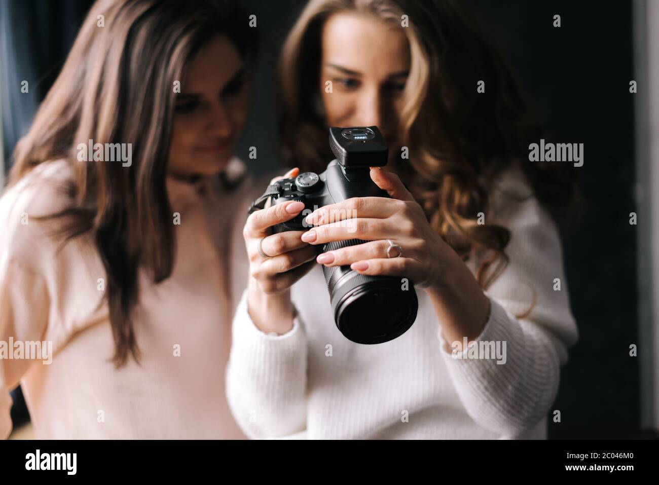 Women model and female photographer watching photos in studio Stock ...
