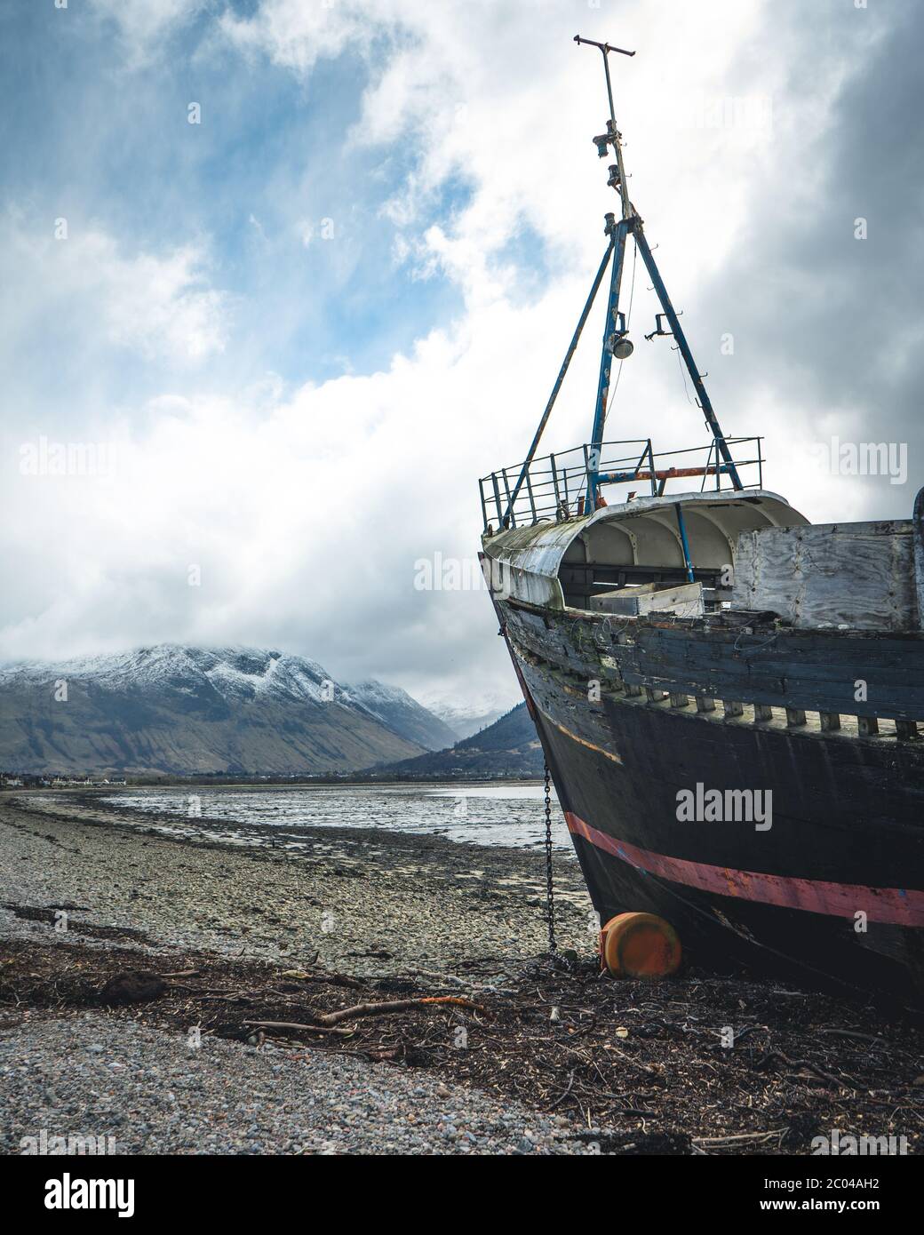 Ship wreck on the beach at low tide. The Old Boat of Corpach, Ben Navis ...