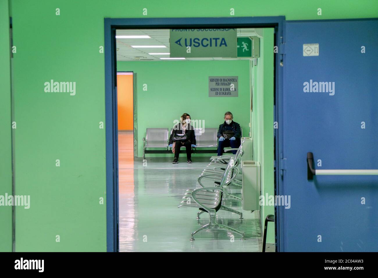 Green waiting room of an Italian hospital with two people waiting ...