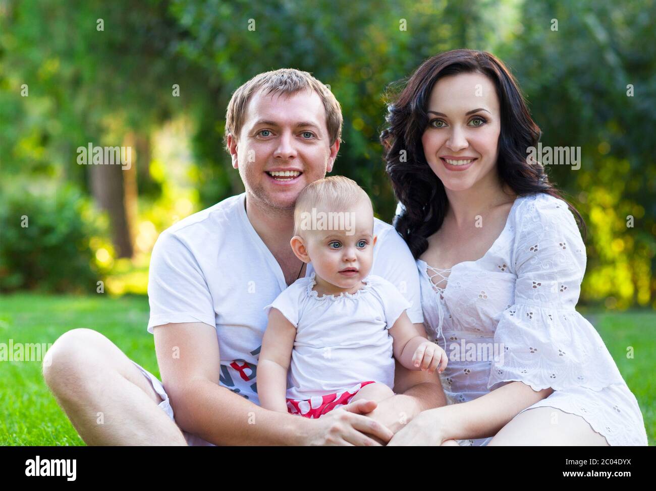 Happy young family with baby girl Stock Photo - Alamy