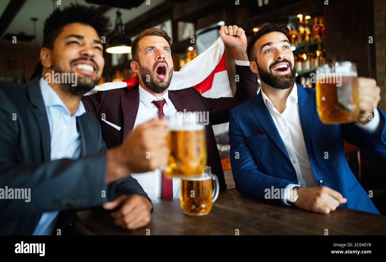 Business men in pub cheering for a sporting event Stock Photo - Alamy