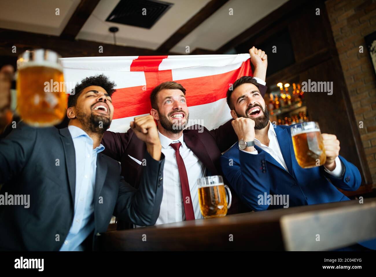 Business men in pub cheering for a sporting event Stock Photo - Alamy