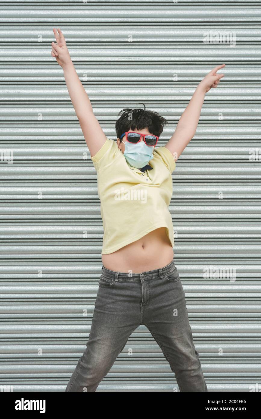 happy kid wearing medical mask jumping on the street outdoor Stock ...