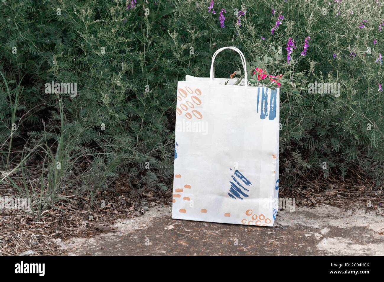 Standing white eco paper bag outside. Remote home delivery of goods and ...