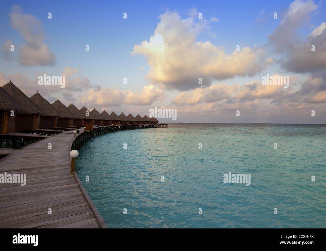Houses over the sea at sunrise. Maldives Stock Photo - Alamy