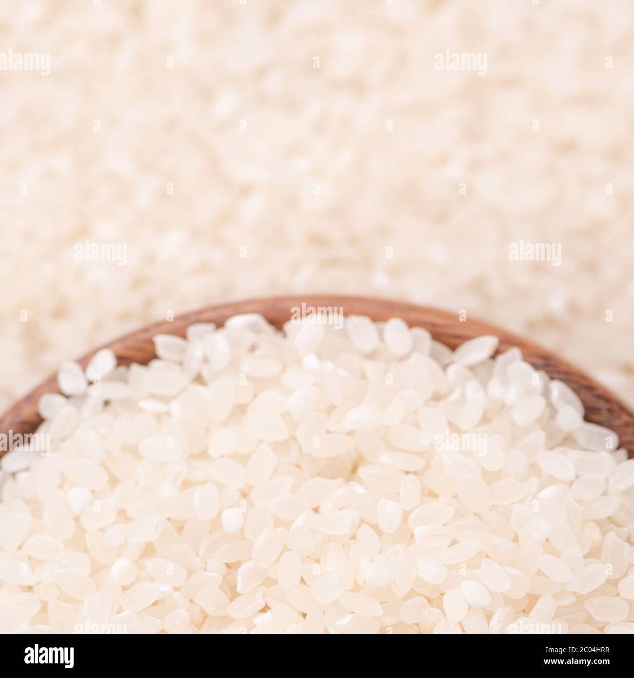 Raw rice in a bowl and full frame in the white background table, top ...