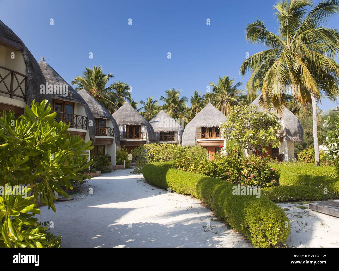 Traditional tropical huts in a garden Stock Photo - Alamy