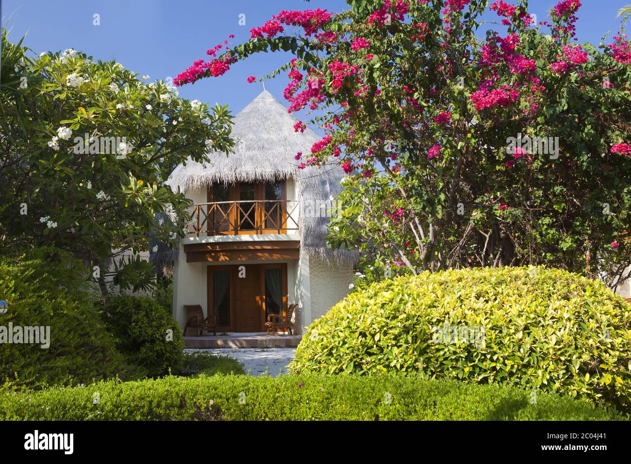 Traditional tropical hut in a garden Stock Photo - Alamy