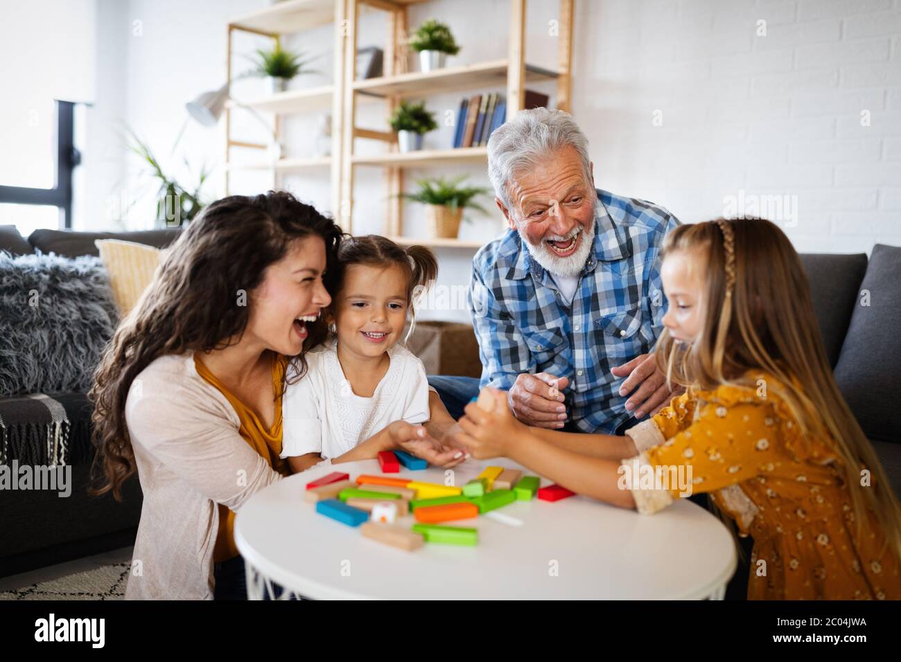 Happy family playing together and having fun at home Stock Photo - Alamy