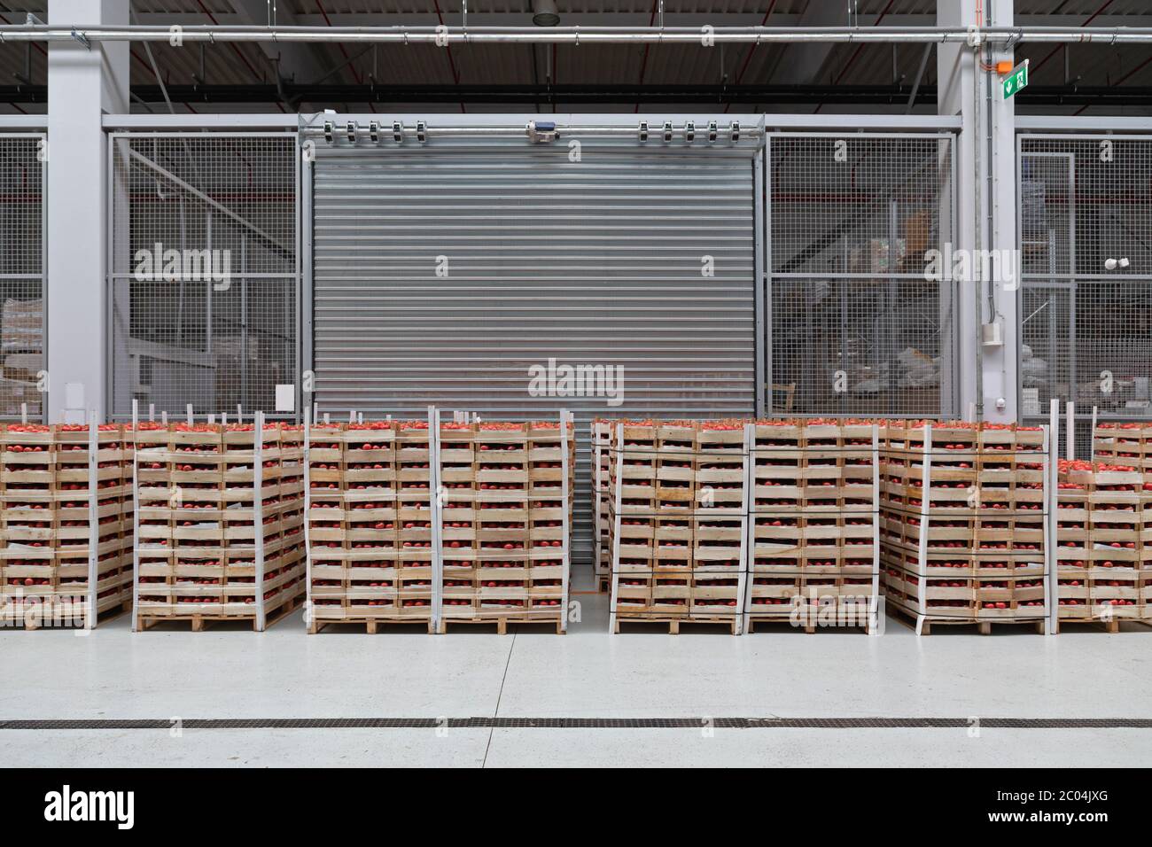 Crates of Tomato at Pallets in Warehouse Stock Photo - Alamy