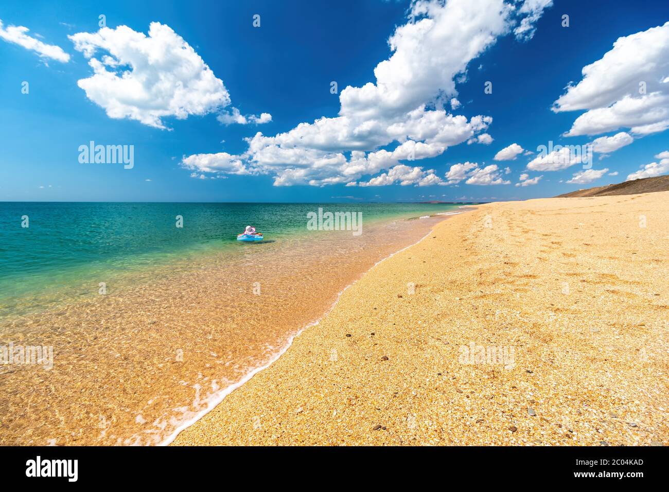 Empty, deserted golden beach with shell sand and crystal clear azure ...
