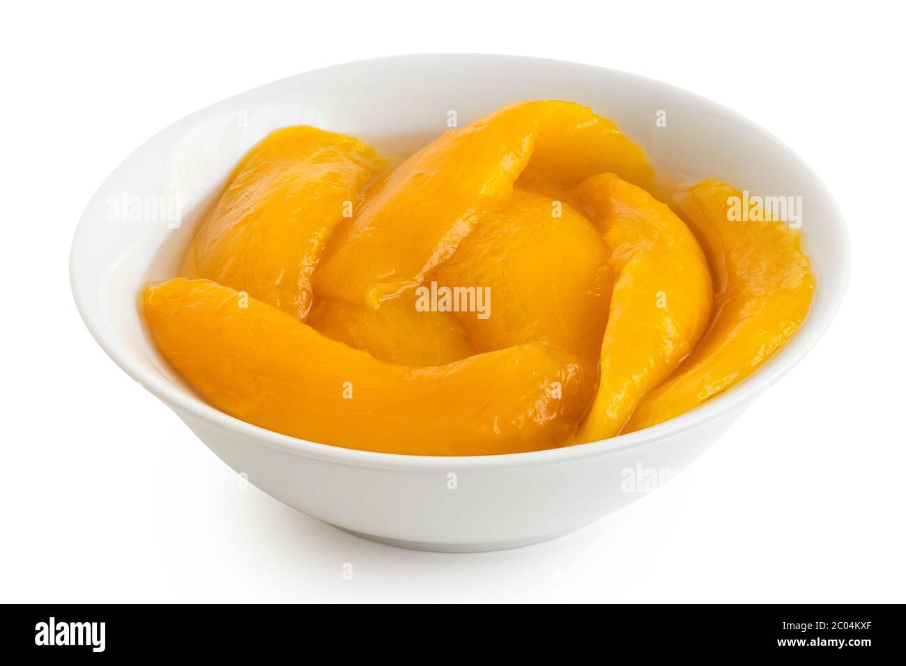 Canned mango slices in syrup in a white ceramic bowl isolated on white ...