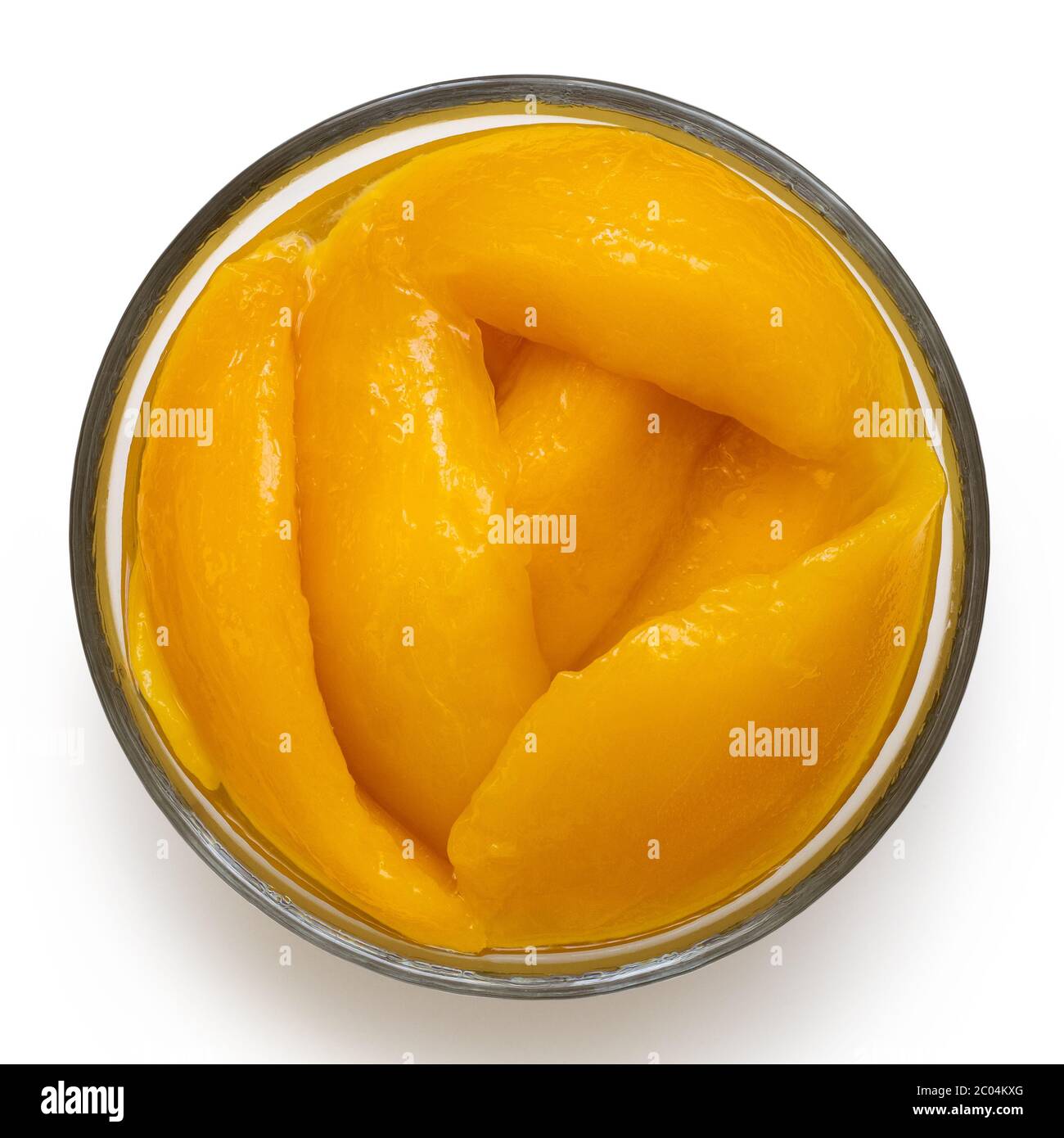 Canned mango slices in syrup in a glass bowl isolated on white. Top ...