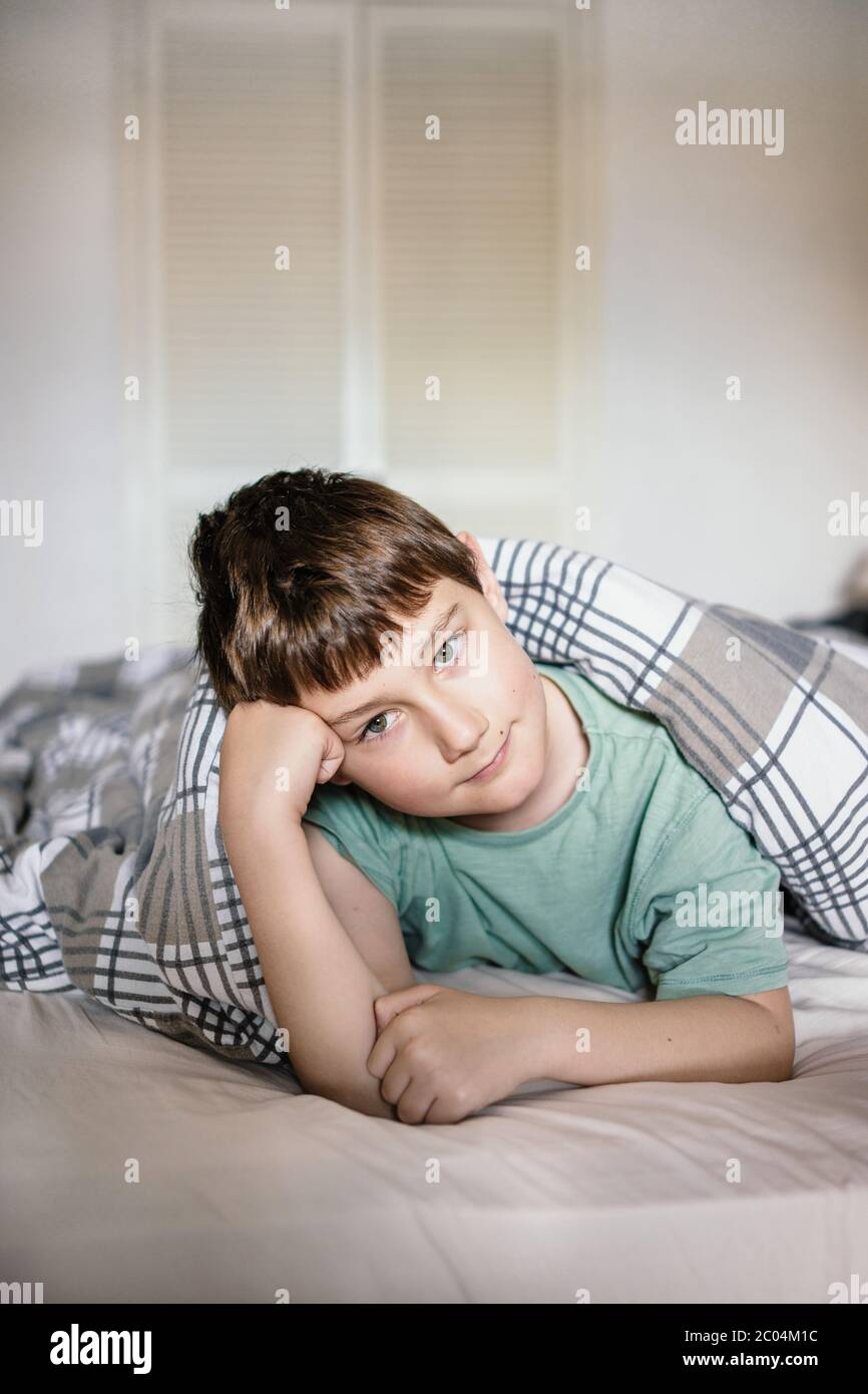 Portrait of a boy in a bed Stock Photo - Alamy