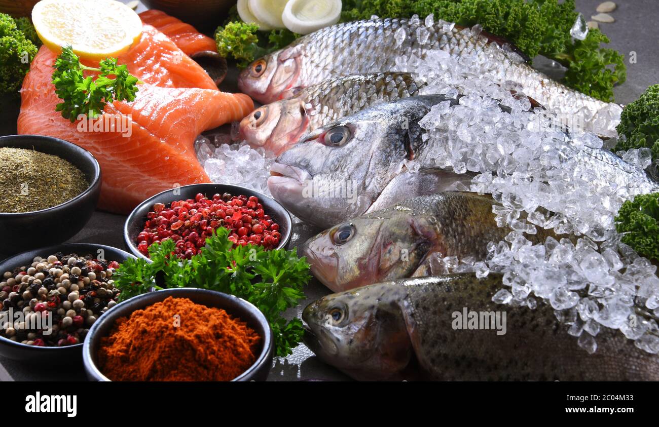 Different sorts of fish on kitchen table Stock Photo - Alamy