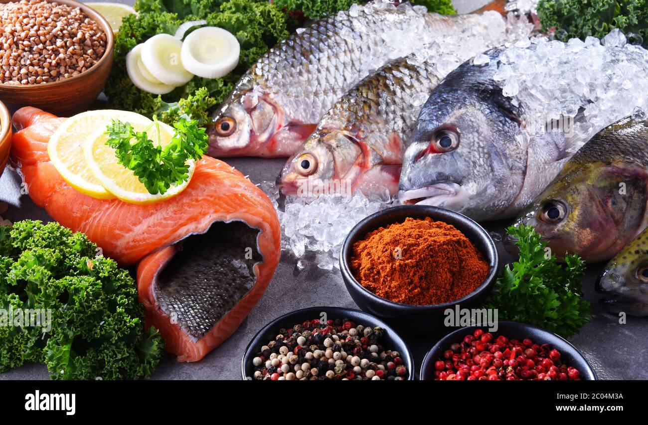 Different sorts of fish on kitchen table Stock Photo - Alamy