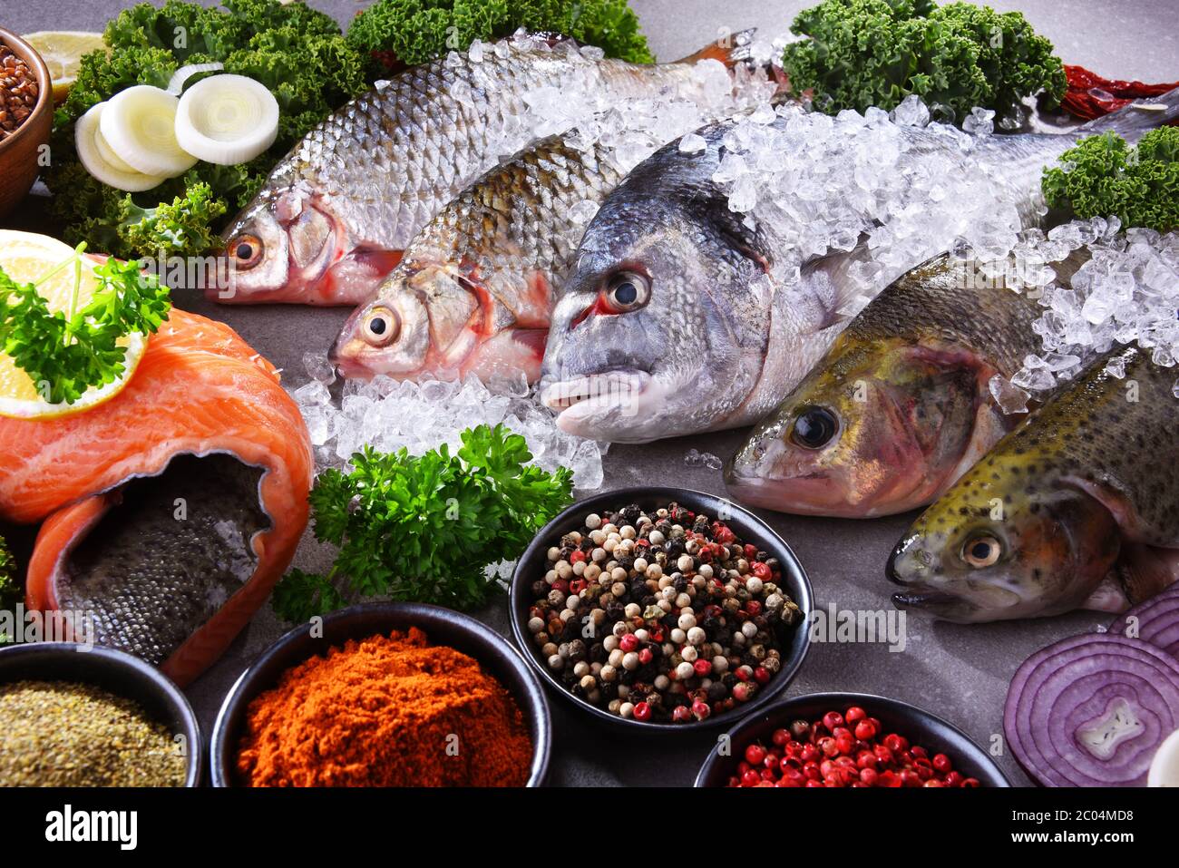 Different sorts of fish on kitchen table Stock Photo - Alamy
