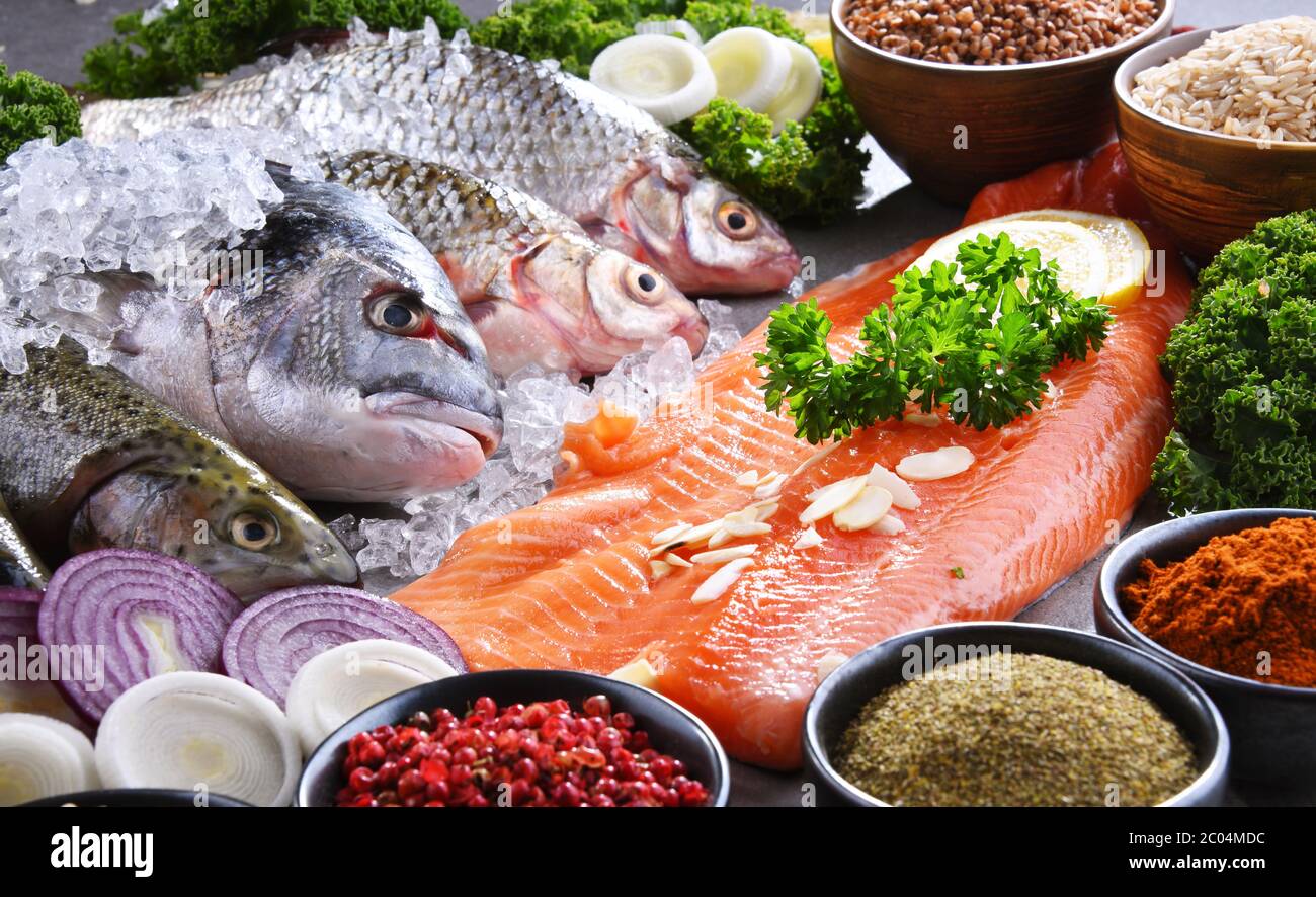 Different sorts of fish on kitchen table Stock Photo - Alamy