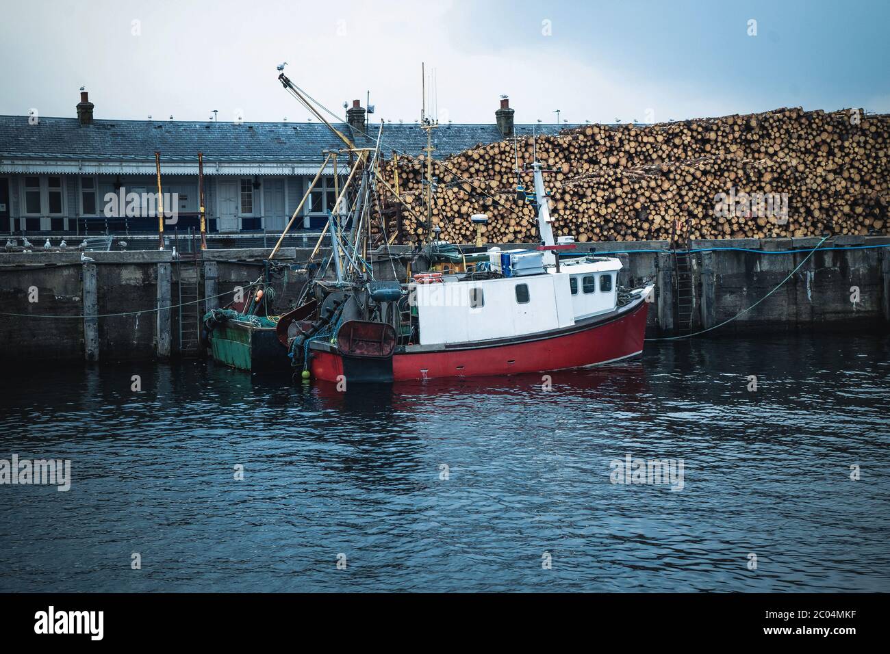 Typical traditional colorful small Scottish fishing boats in a harbor ...