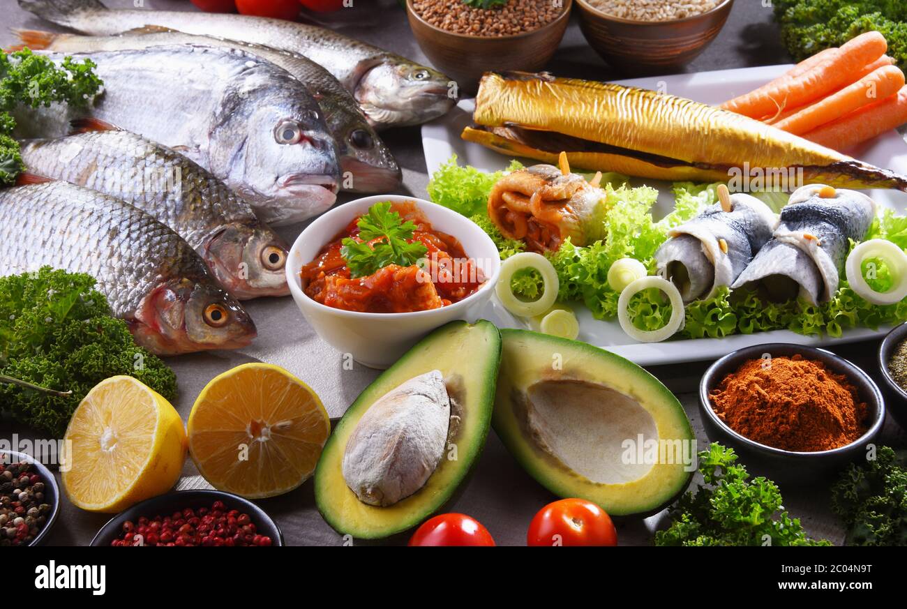Different sorts of fish on kitchen table Stock Photo - Alamy