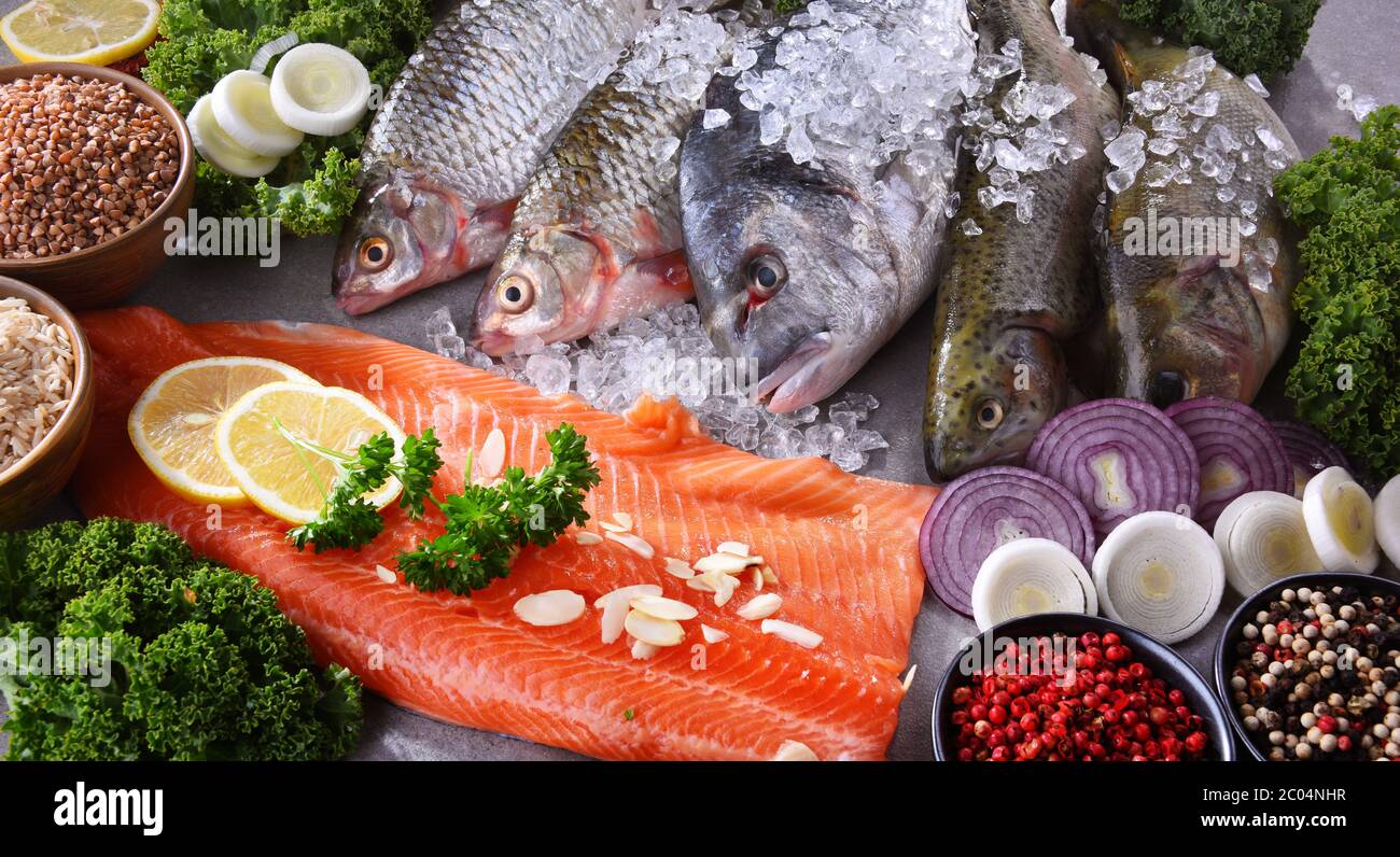 Different sorts of fish on kitchen table Stock Photo - Alamy