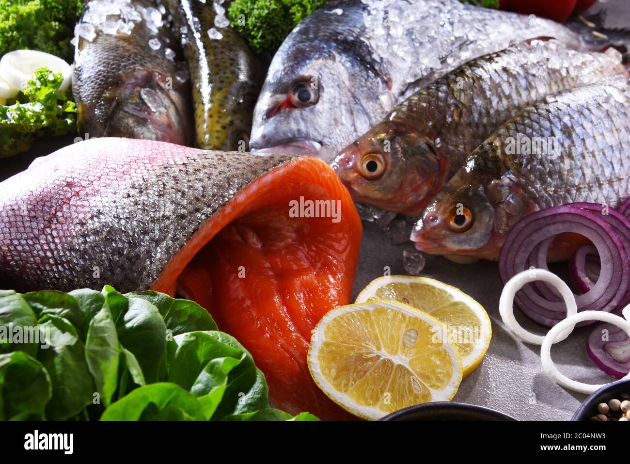 Different sorts of fish on kitchen table Stock Photo - Alamy