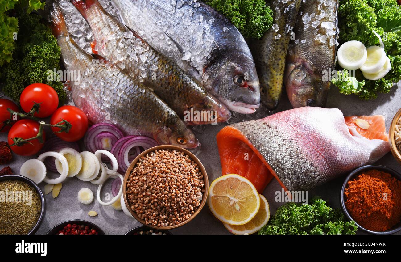 Different sorts of fish on kitchen table Stock Photo - Alamy