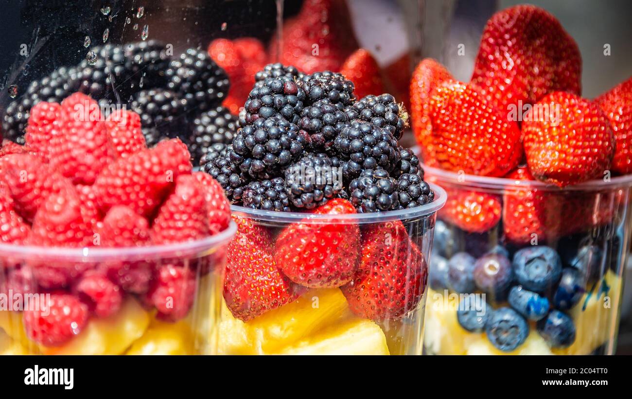 Colorful different fruit sets at street cafe, outdoor, summer time ...