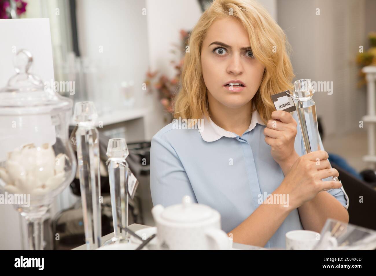 Shocked woman showing price tag hi-res stock photography and images - Alamy
