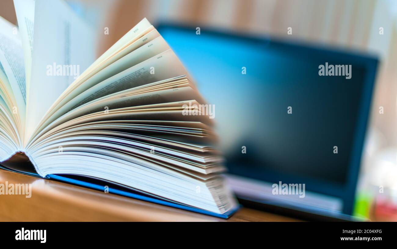 Open book lying on the table in the public library Stock Photo - Alamy