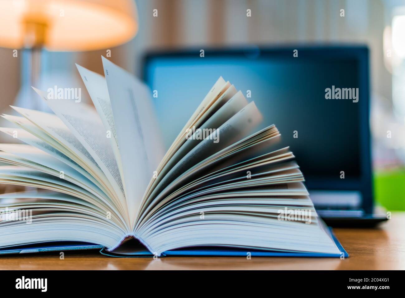 Open book lying on the table in the public library Stock Photo - Alamy