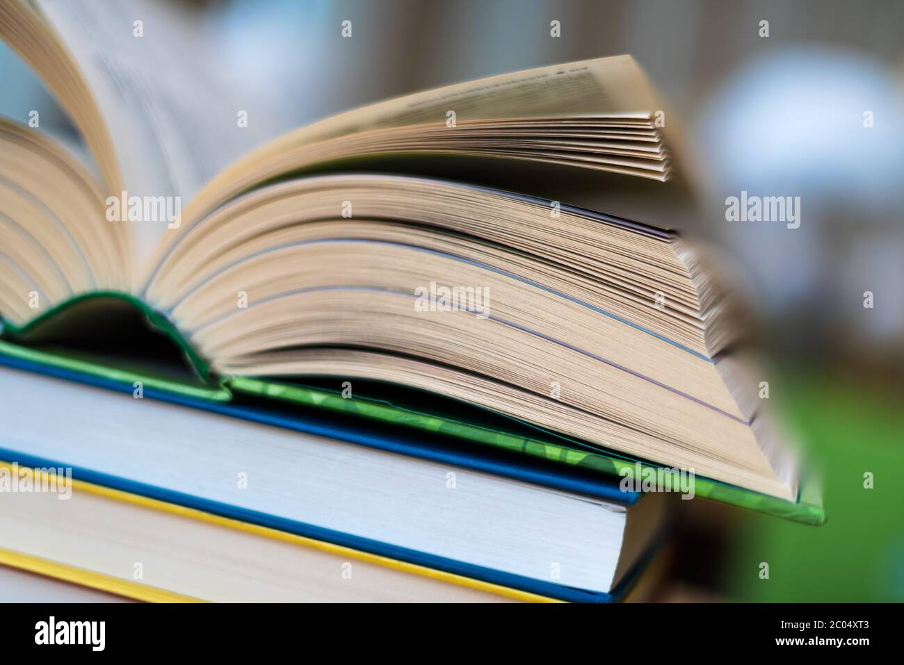 Open book lying on the table in the public library Stock Photo - Alamy