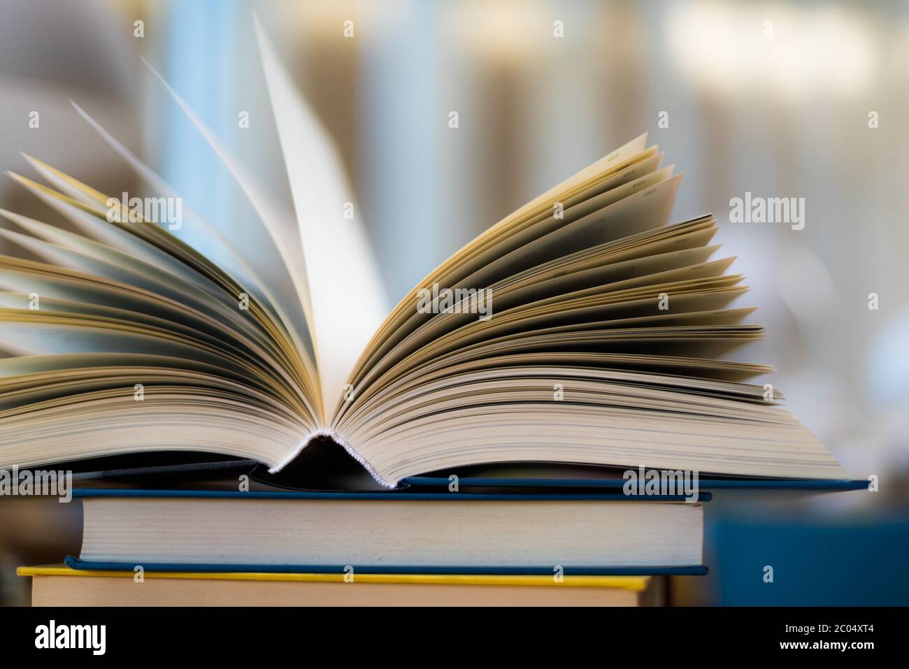 Open book lying on the table in the public library Stock Photo - Alamy