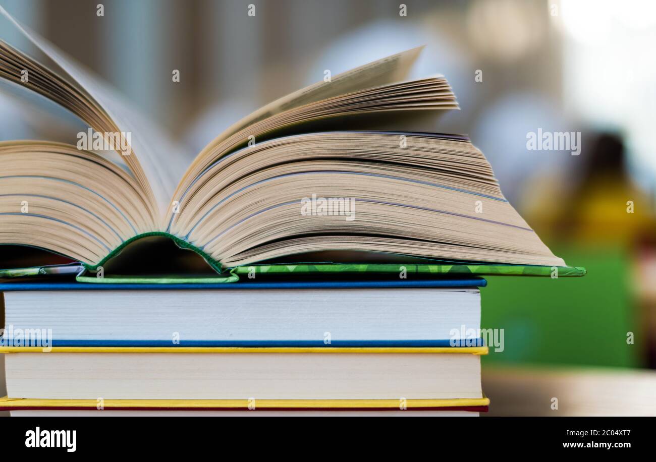 Open book lying on the table in the public library Stock Photo - Alamy