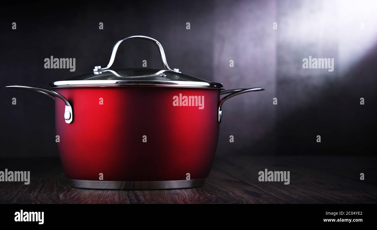 Composition with red steel pot Stock Photo - Alamy