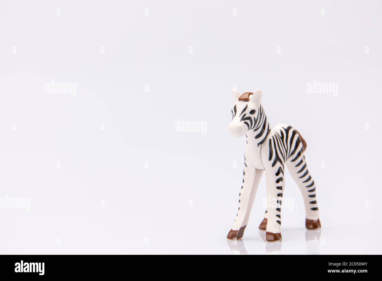 close up of a plastic stripped zebra isolated on a white background ...