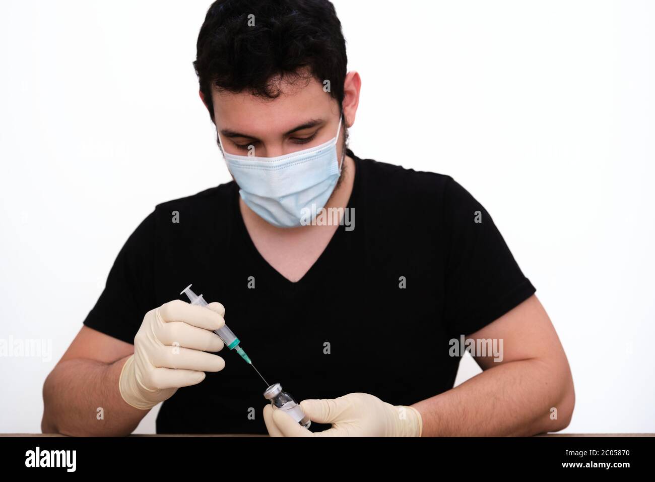 Male nurse getting a shot ready for injection. Coronavirus vaccine ...