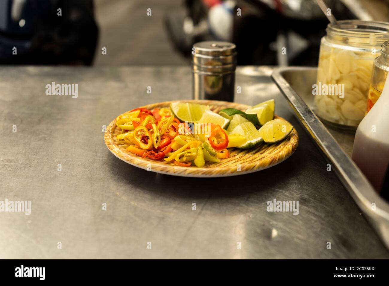 Traditional Vietnamese noodle condiment tray with dish of lemon slices ...