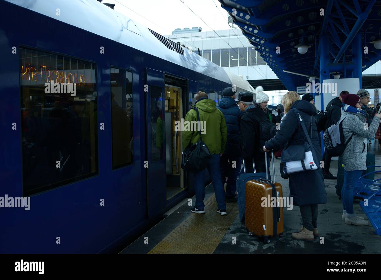 Group of passengers standing in front of doors of the passenger train ...